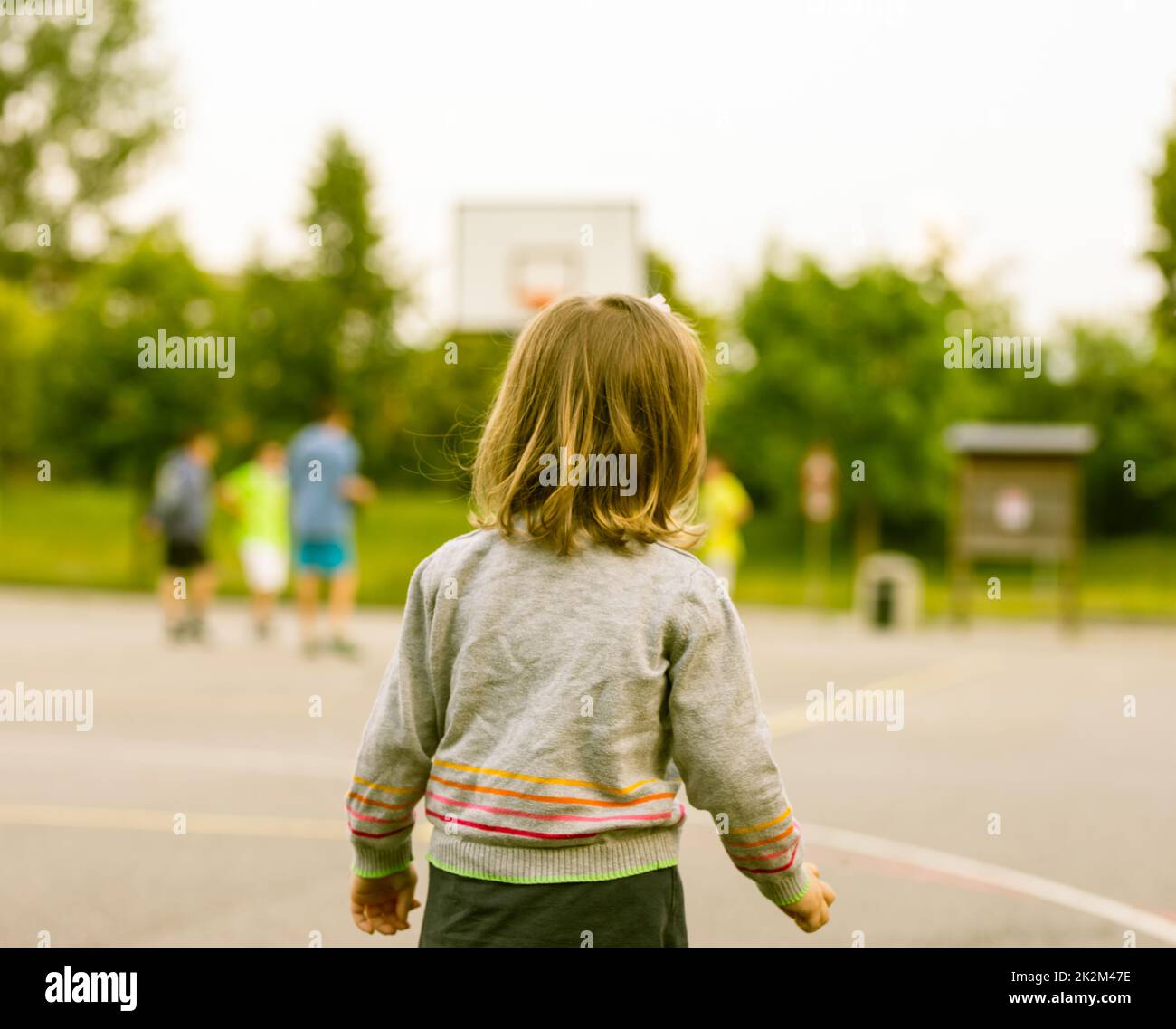 girls watching babies in the park from behind Stock Photo - Alamy