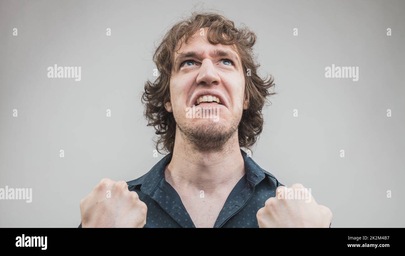 bad man expressing anger with face and hands Stock Photo - Alamy