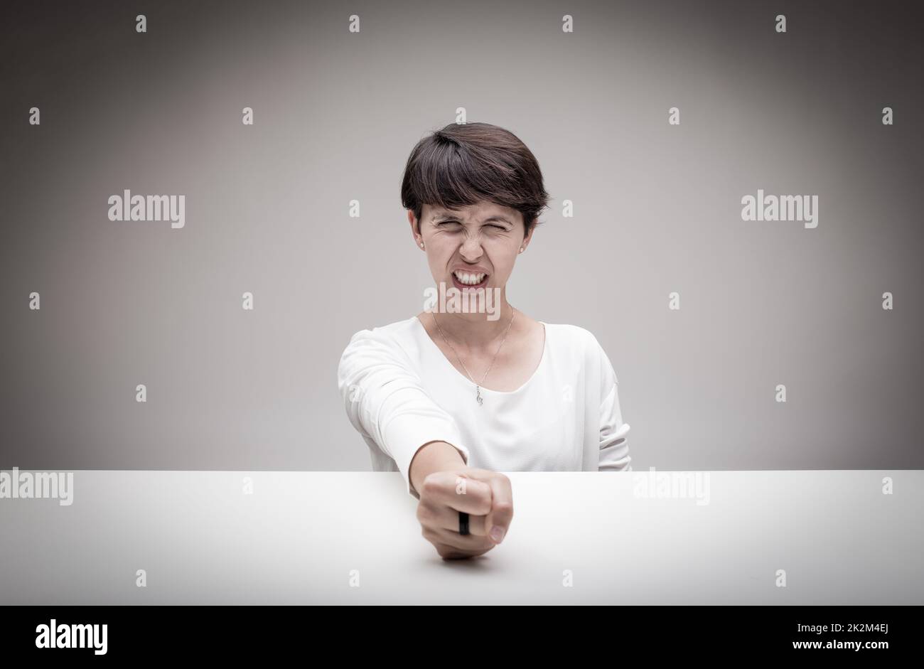 angry woman hitting her fist on the table Stock Photo - Alamy