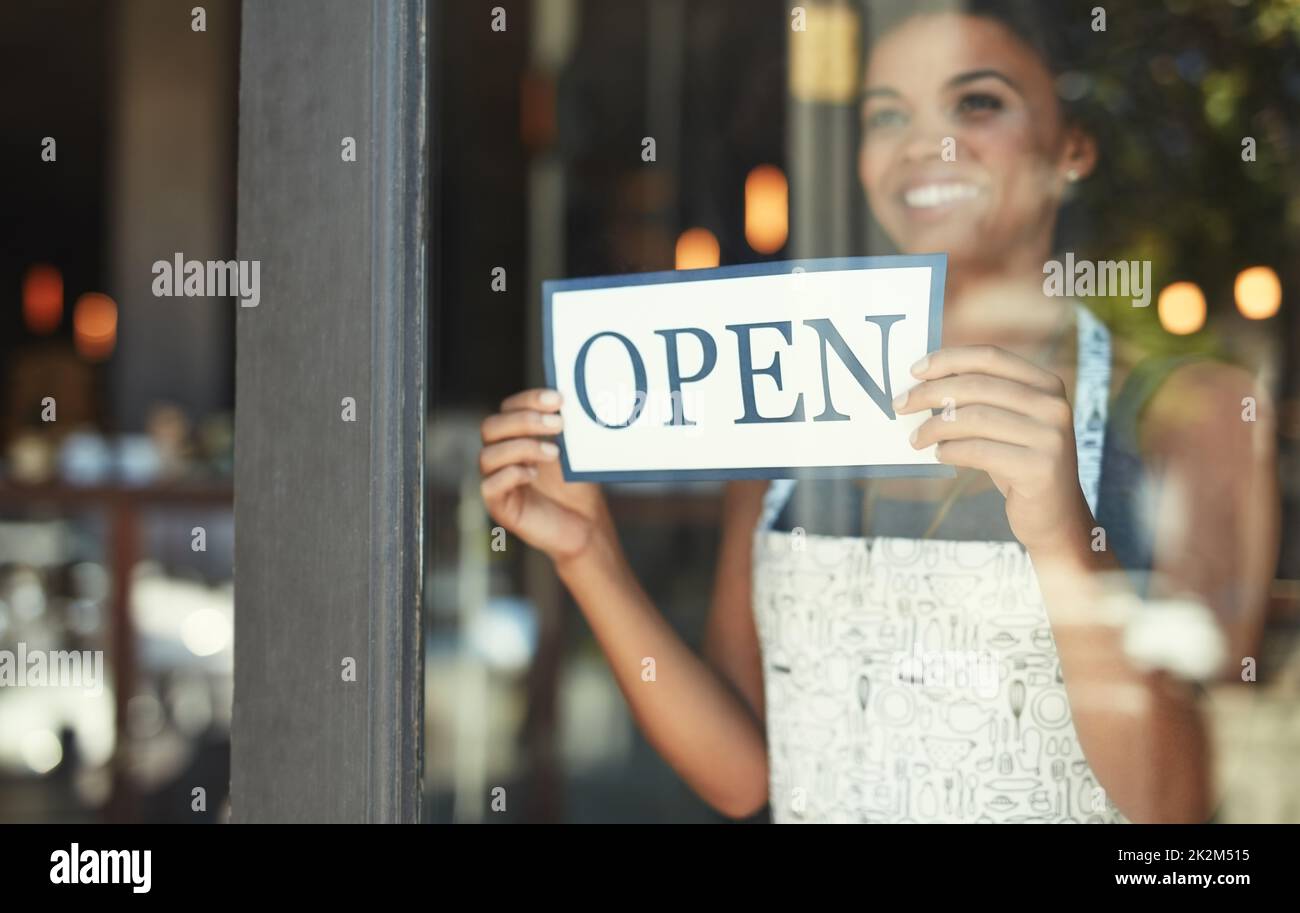 The best cafe in town is now open for business. Cropped shot of a young ...