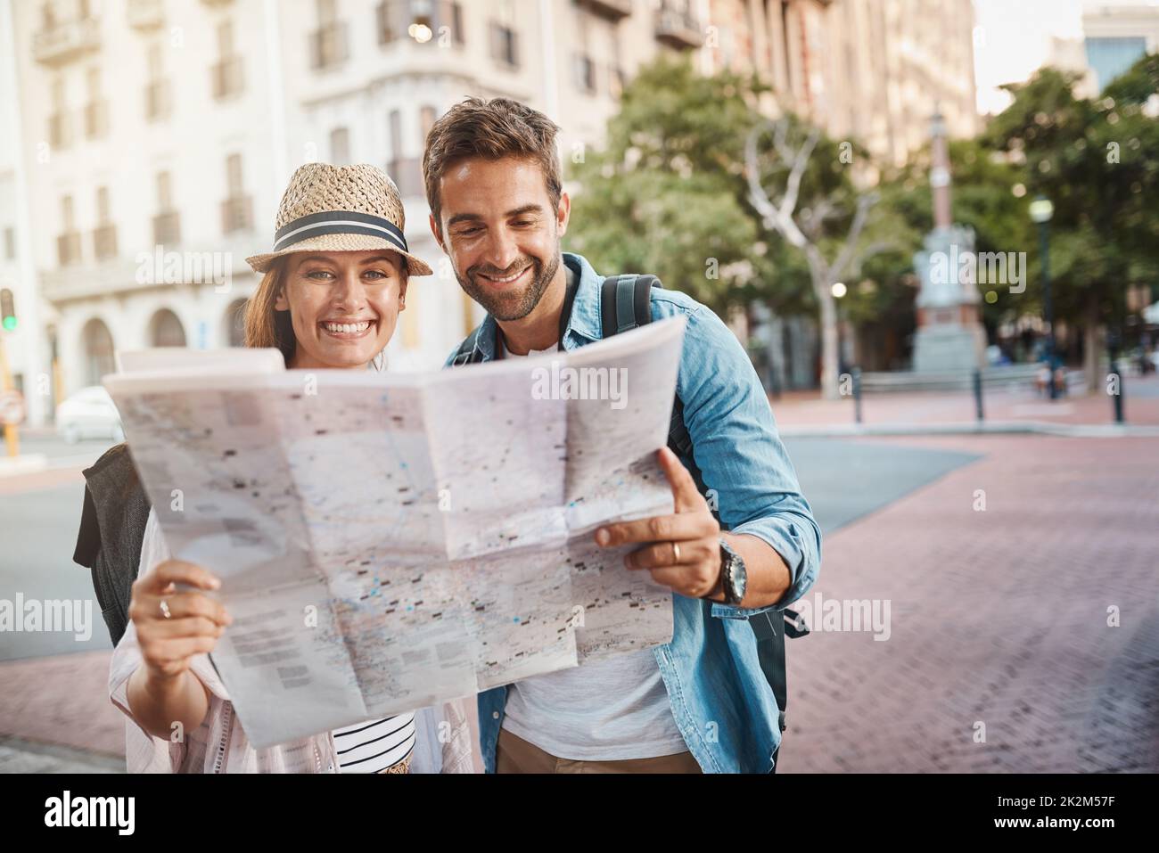 Two happy young women camera map hi-res stock photography and images ...