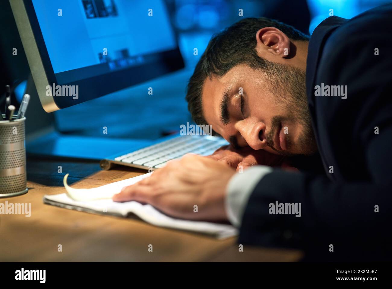 Working himself to death. Shot of an exhausted young businessman ...
