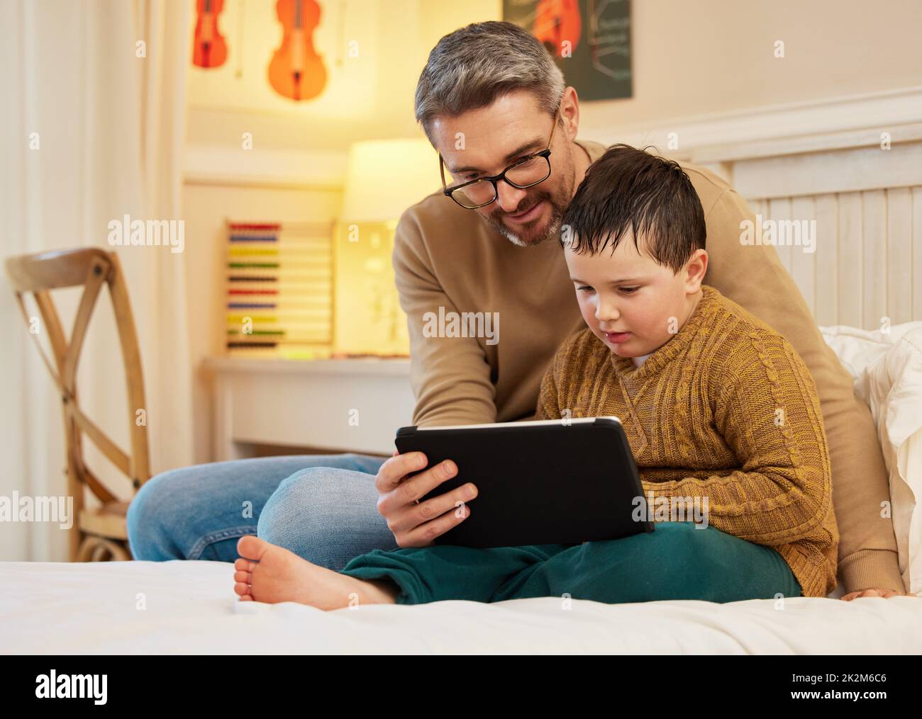 Ill let you watch one last episode before bed. Shot of a father and son ...