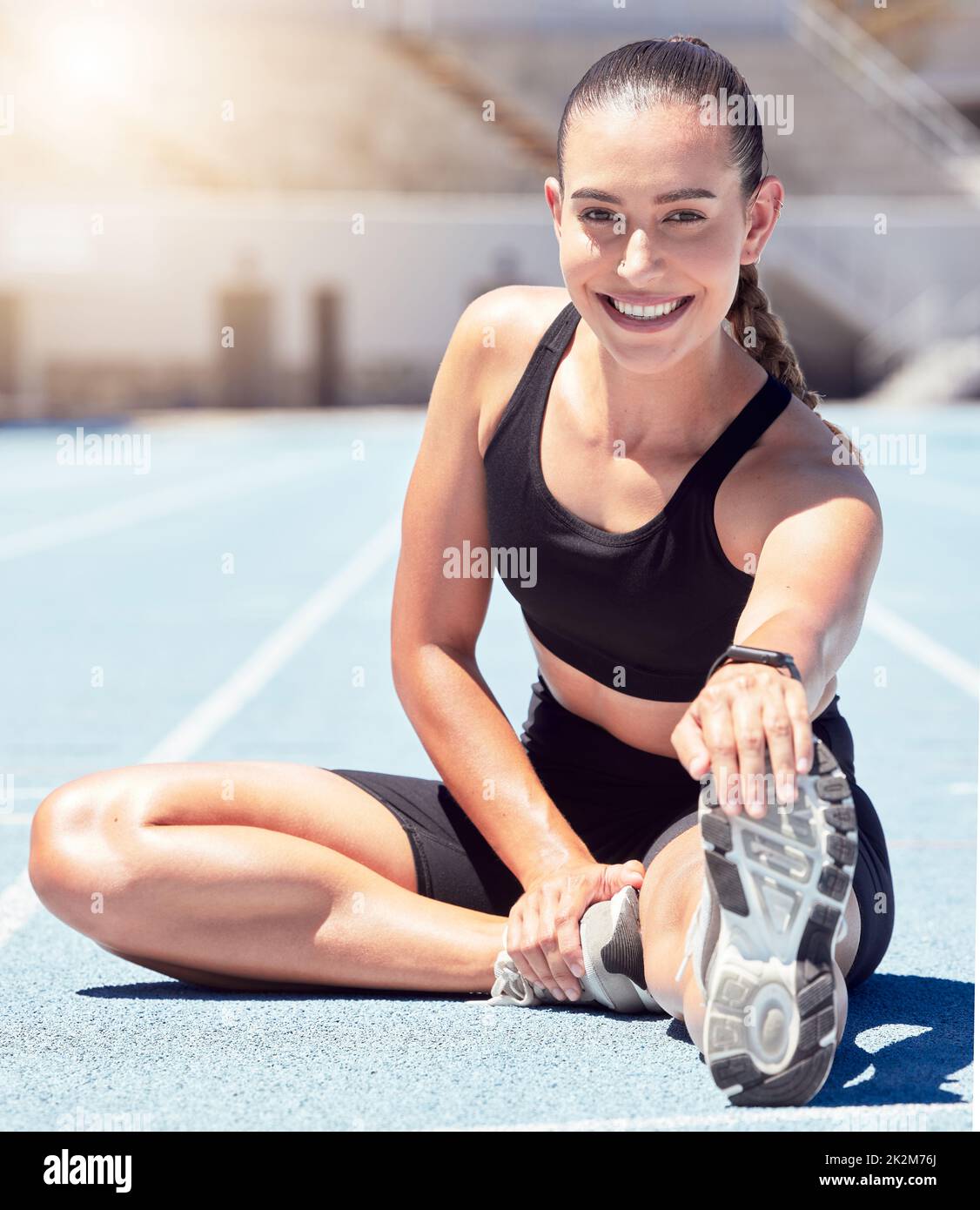 Portrait, woman and stretching runner exercise at outdoor track, happy ...