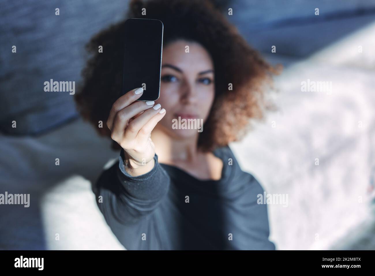 confident young woman taking a selfie on her mobile phone Stock Photo - Alamy
