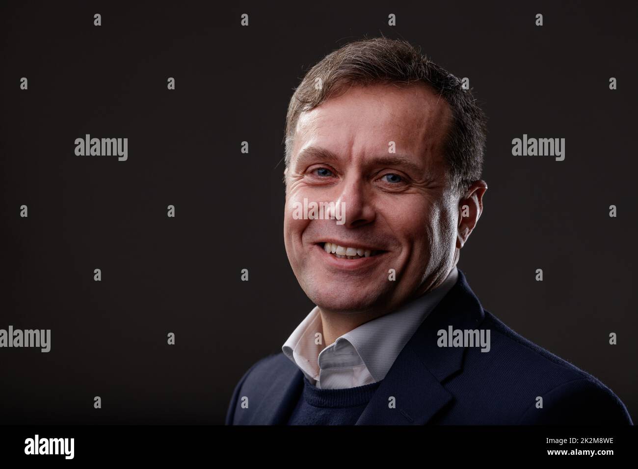 Confident attractive professional man with friendly smile Stock Photo ...