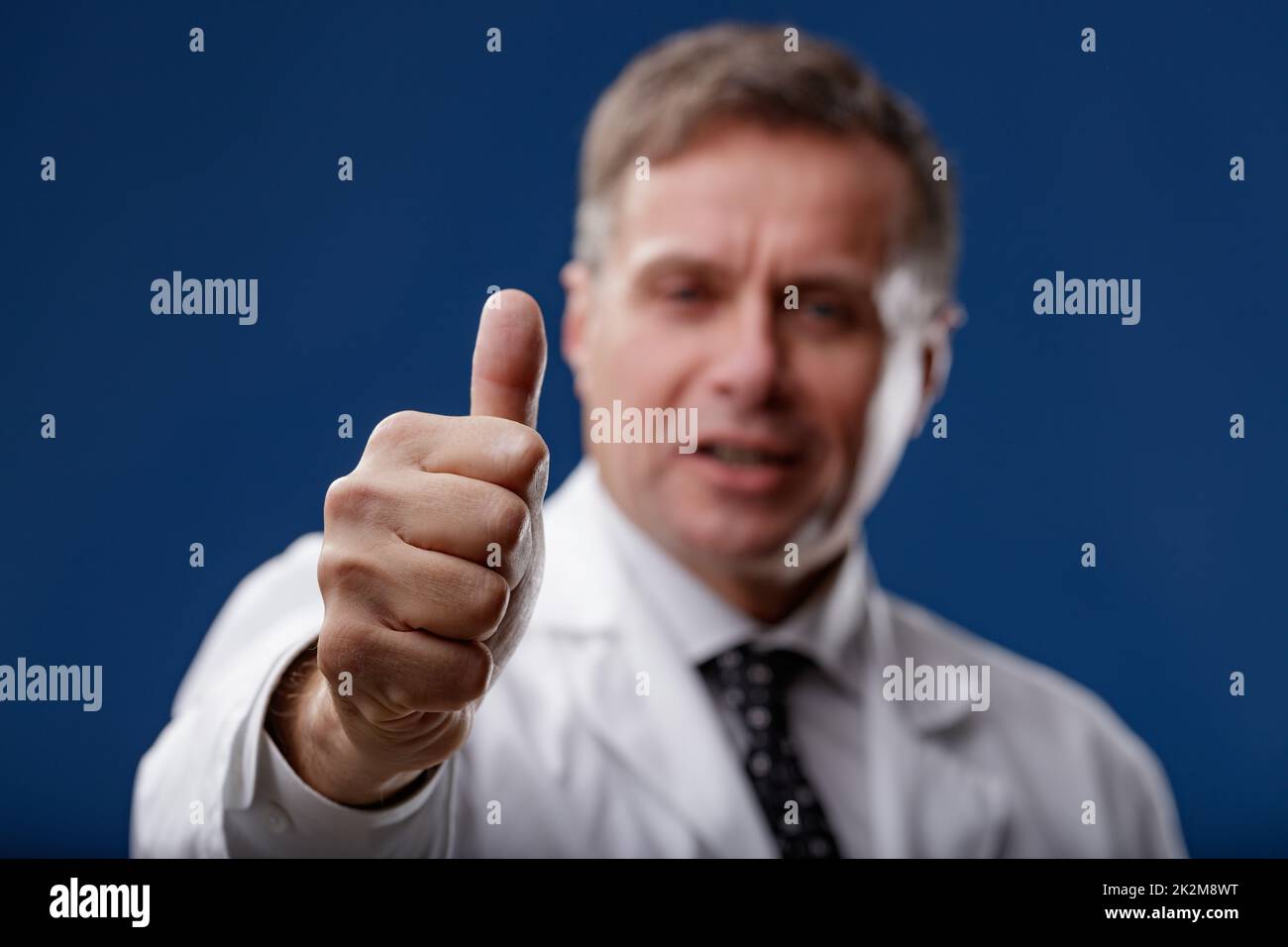 Portrait of a doctor showing thumbs up positive feedback Stock Photo ...