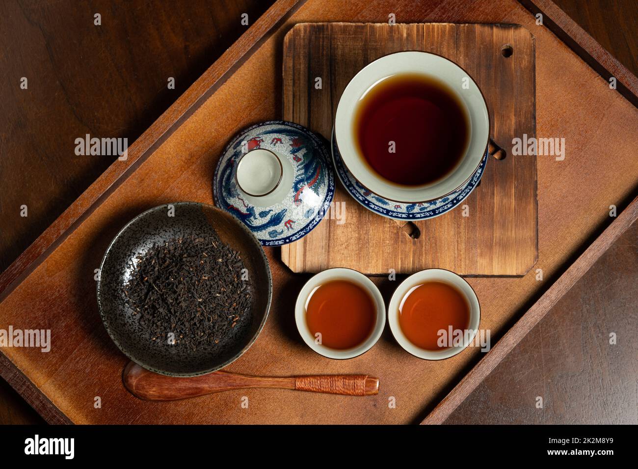chinese traditional porcelain tea cup and tea leaf on wooden ancient ...
