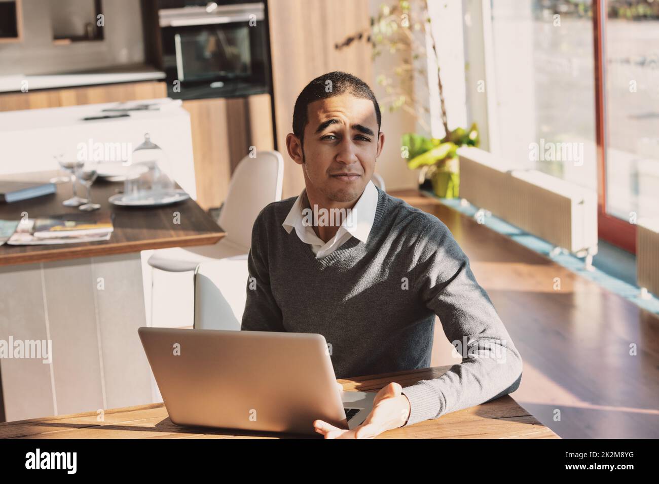 Sceptical young man pulling a face as he looks at the camera Stock ...