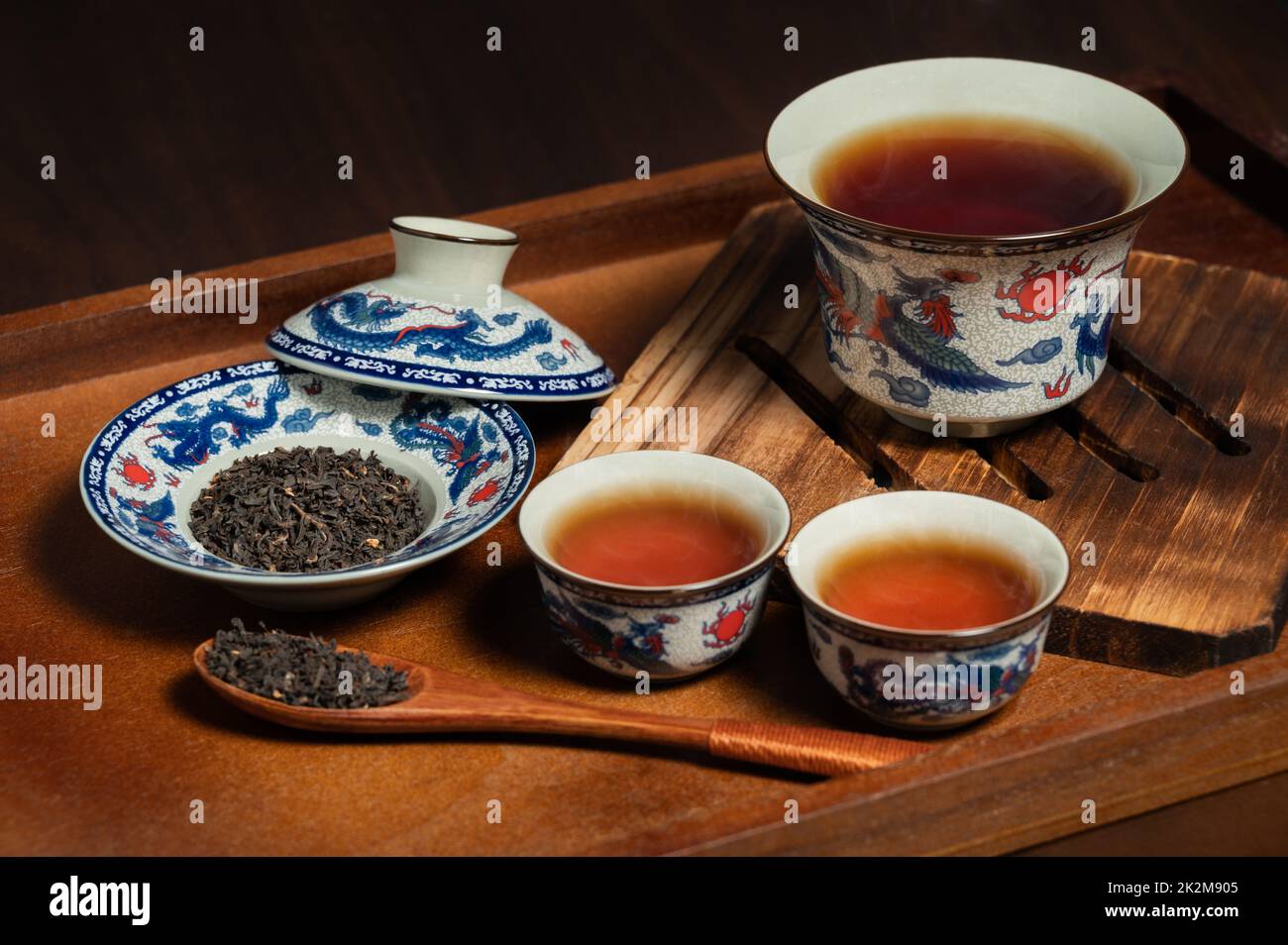 chinese traditional porcelain tea cup and tea leaf on wooden ancient ...