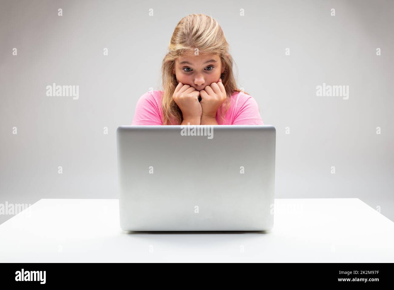 Young girl staring aghast at her laptop Stock Photo - Alamy