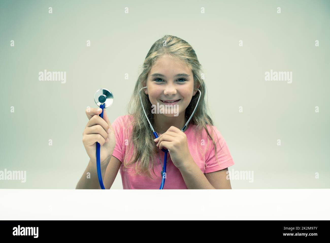 Happy smiling little girl holding a stethoscope Stock Photo - Alamy
