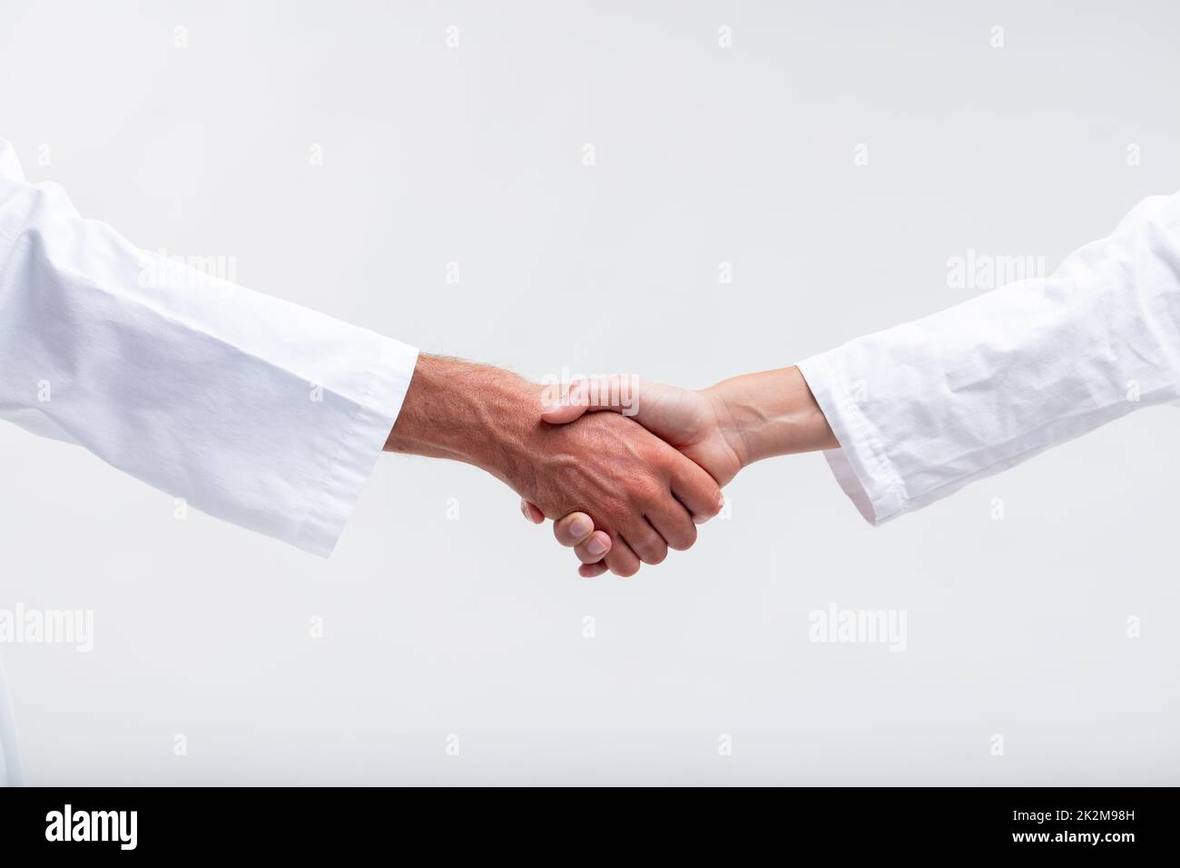 Two medical personnel shaking hands Stock Photo - Alamy