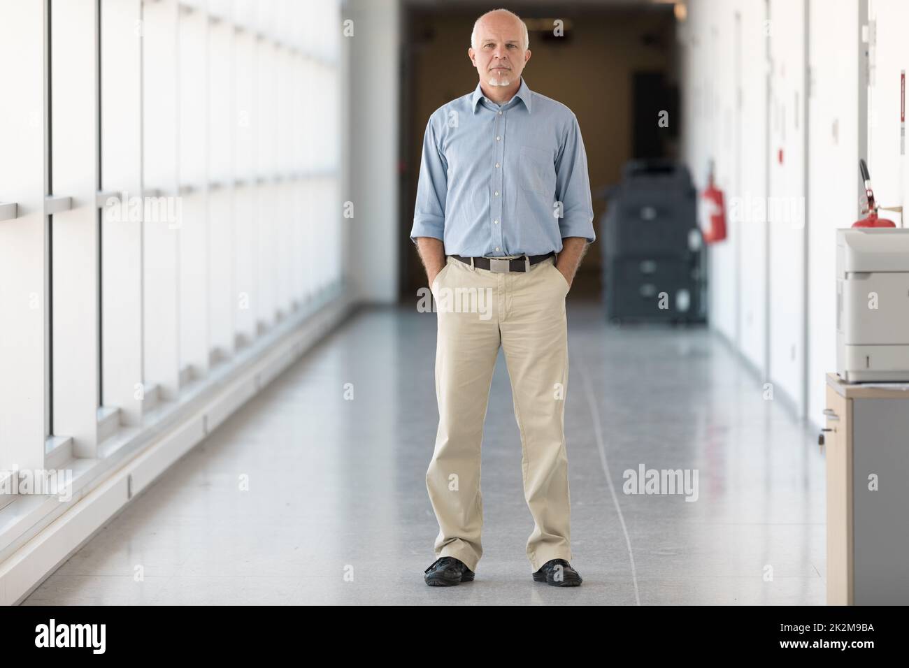 full-length portrait of a man standing in the hallway inside a new ...