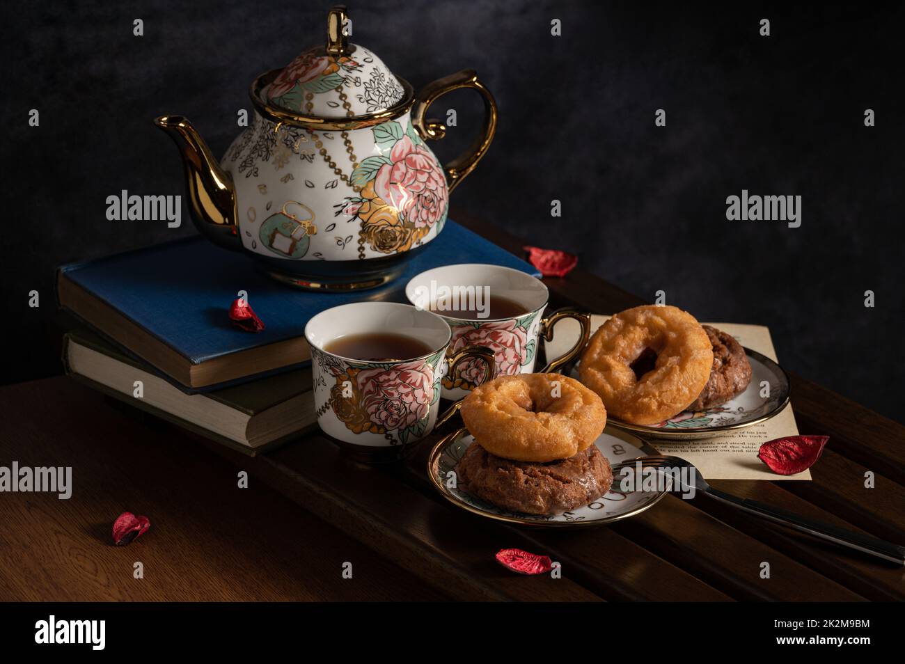 afternoon tea image with black tea,donuts and beautiful teapot and cup ...