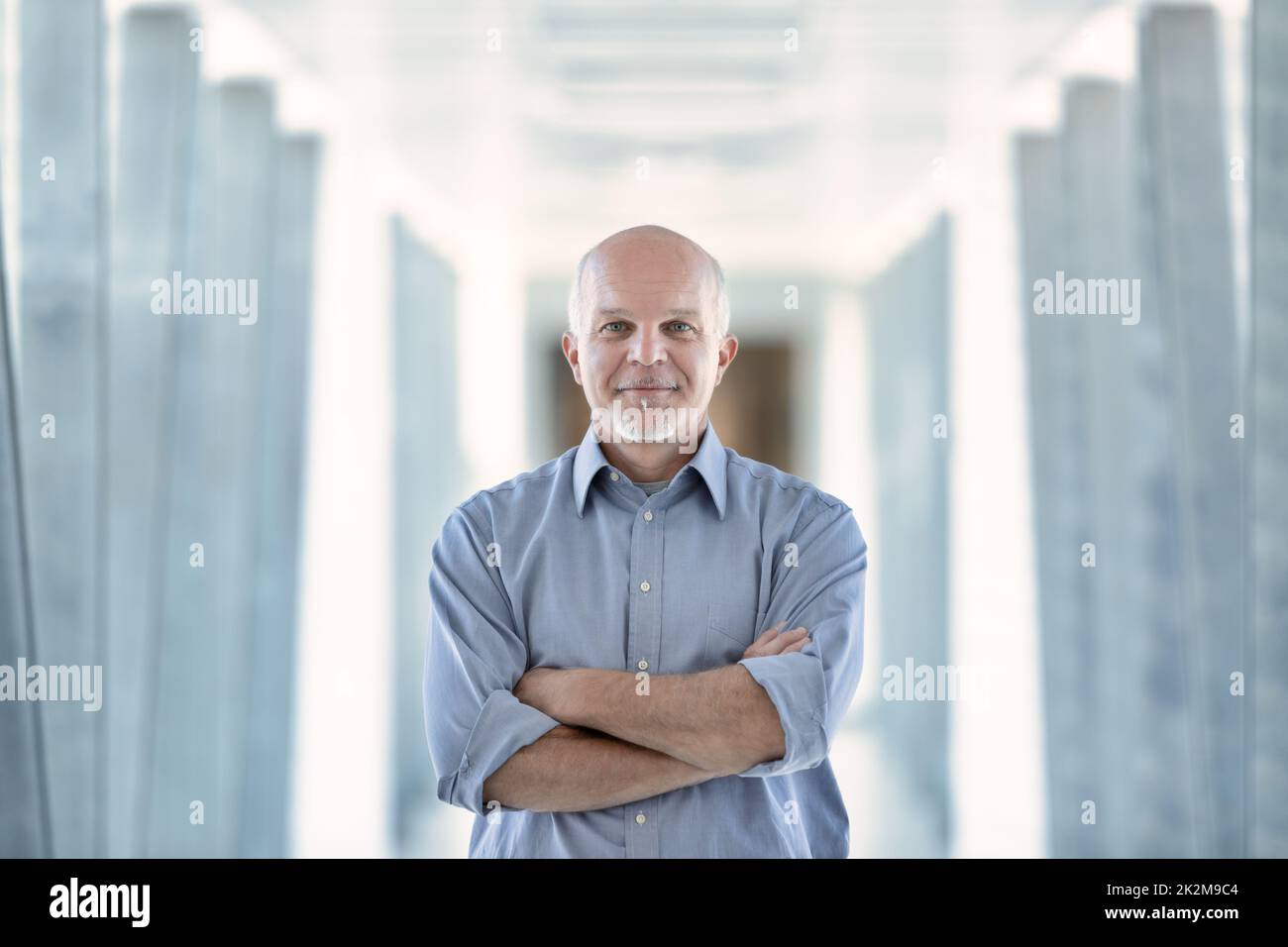 Confident friendly man standing with folded arms and a smile Stock ...