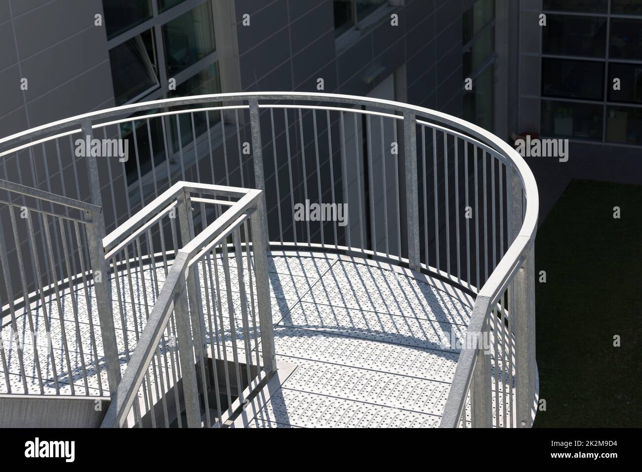outdoors modern emergency spiral staircase with protective railing and ...