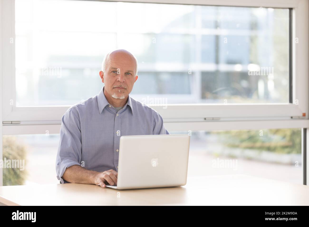 Portrait businessman sitting computer hi-res stock photography and ...