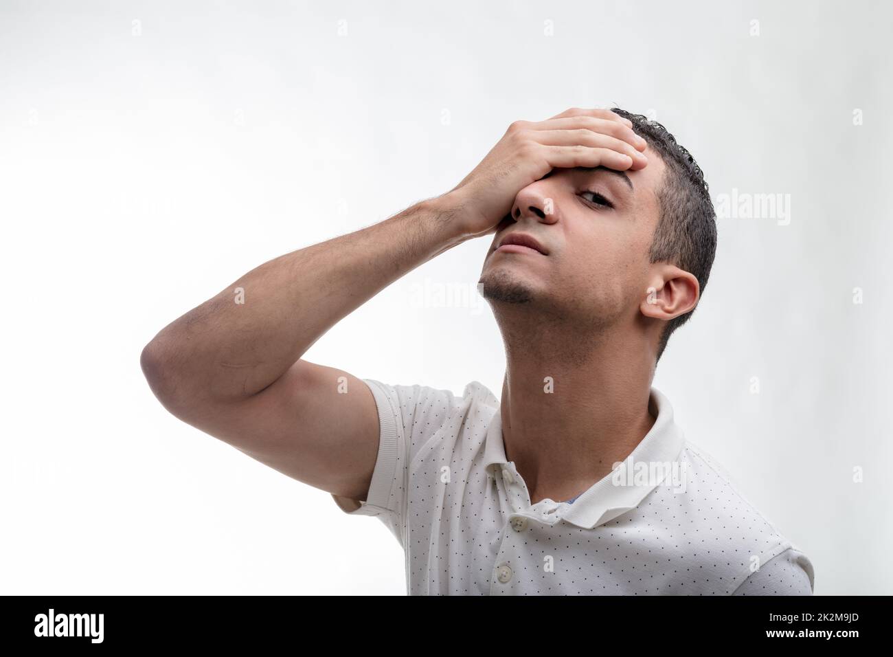 Man covering one eye with his hand Stock Photo - Alamy