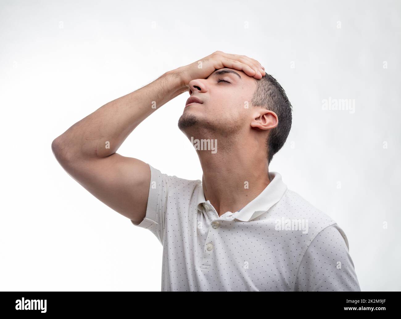 Man placing his hand on his forehead Stock Photo - Alamy