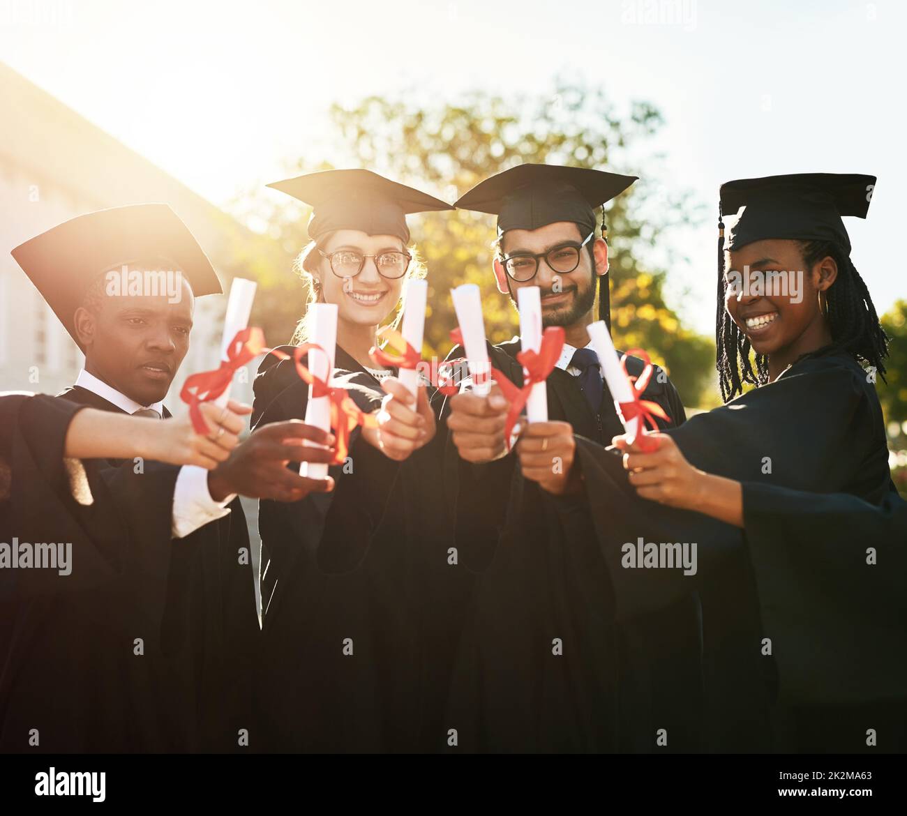 Weve only just begun. Shot of a group of students holding their ...