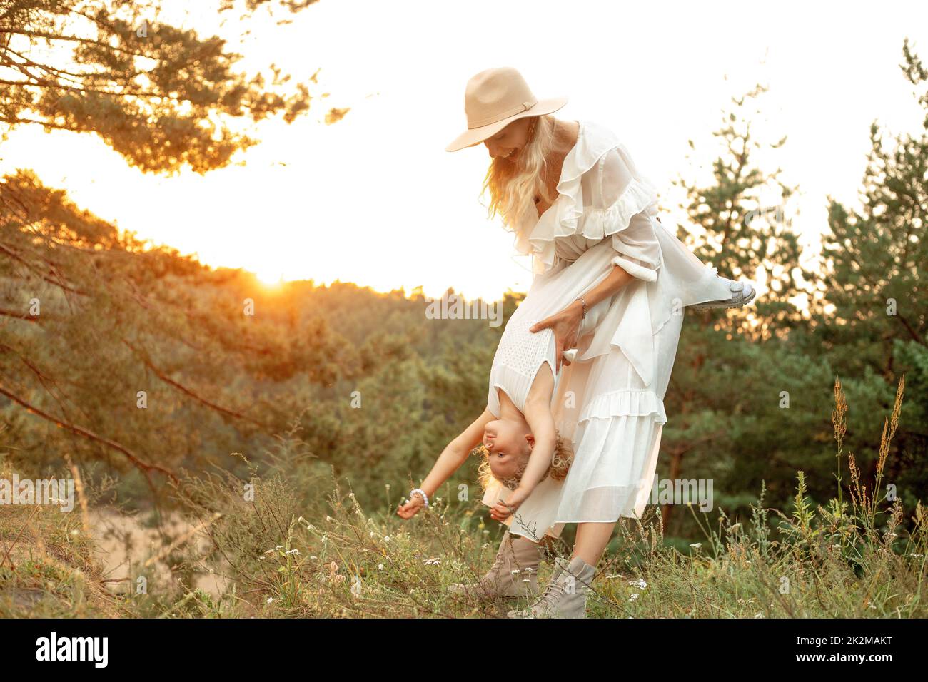 Mother holding daughter upside down hi-res stock photography and images - Alamy