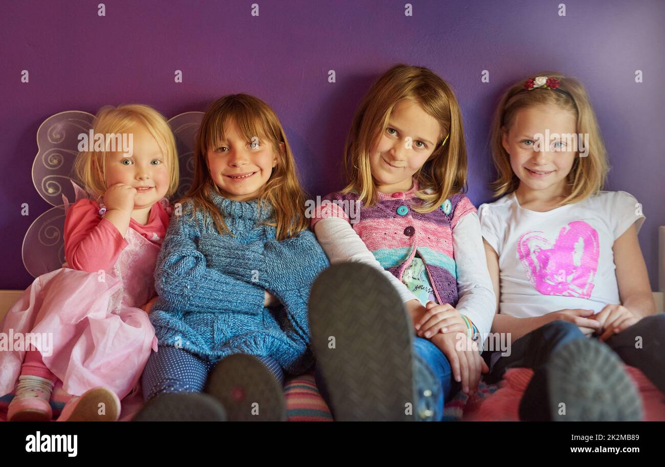 Cheerful childhood days. Portrait of a group of little girls sitting ...
