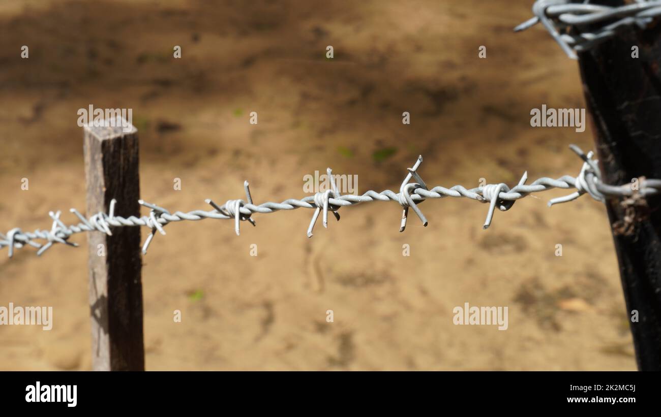 Barbed wire. Part of guarding farm fence. A close up of a barbed wire ...