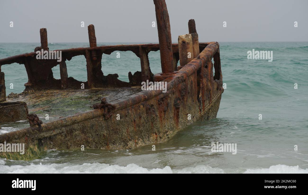 View of a rusty shipwreck in HaBonim Beach in stormy day. Habonim shore ...