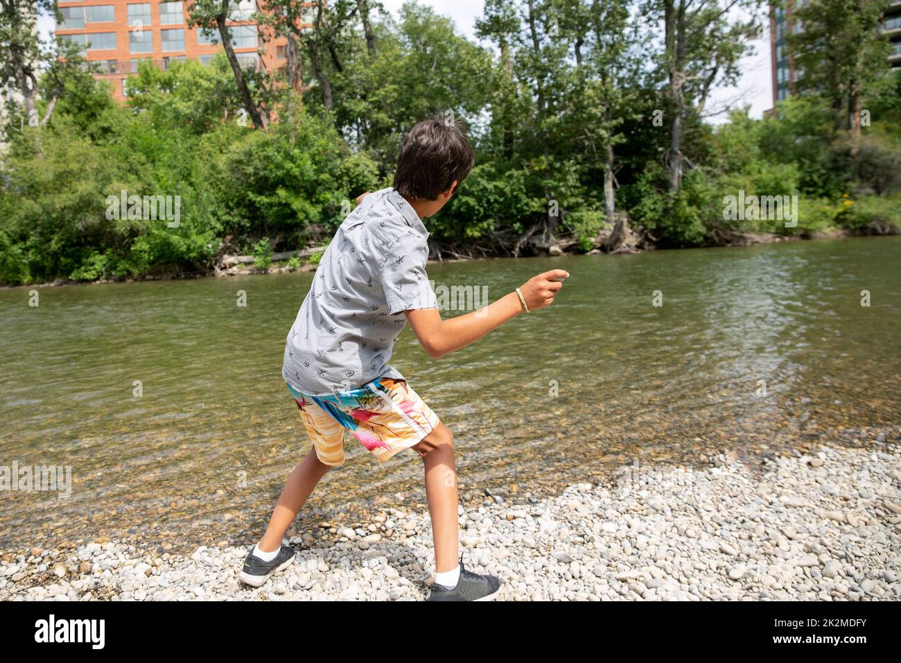 Child throwing stone hi-res stock photography and images - Alamy