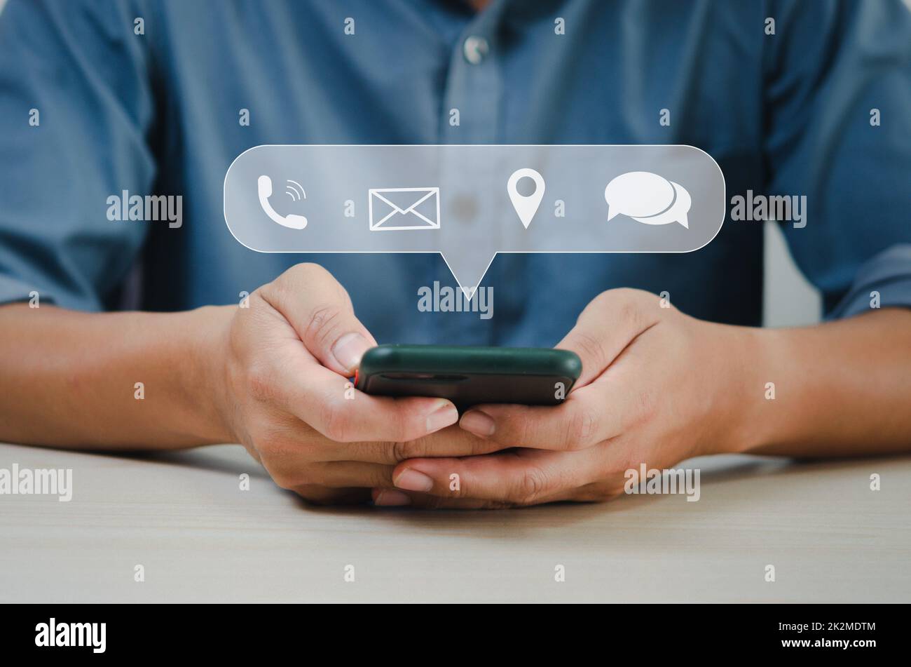 Businessman hand holding a smart phone using contact information and ...