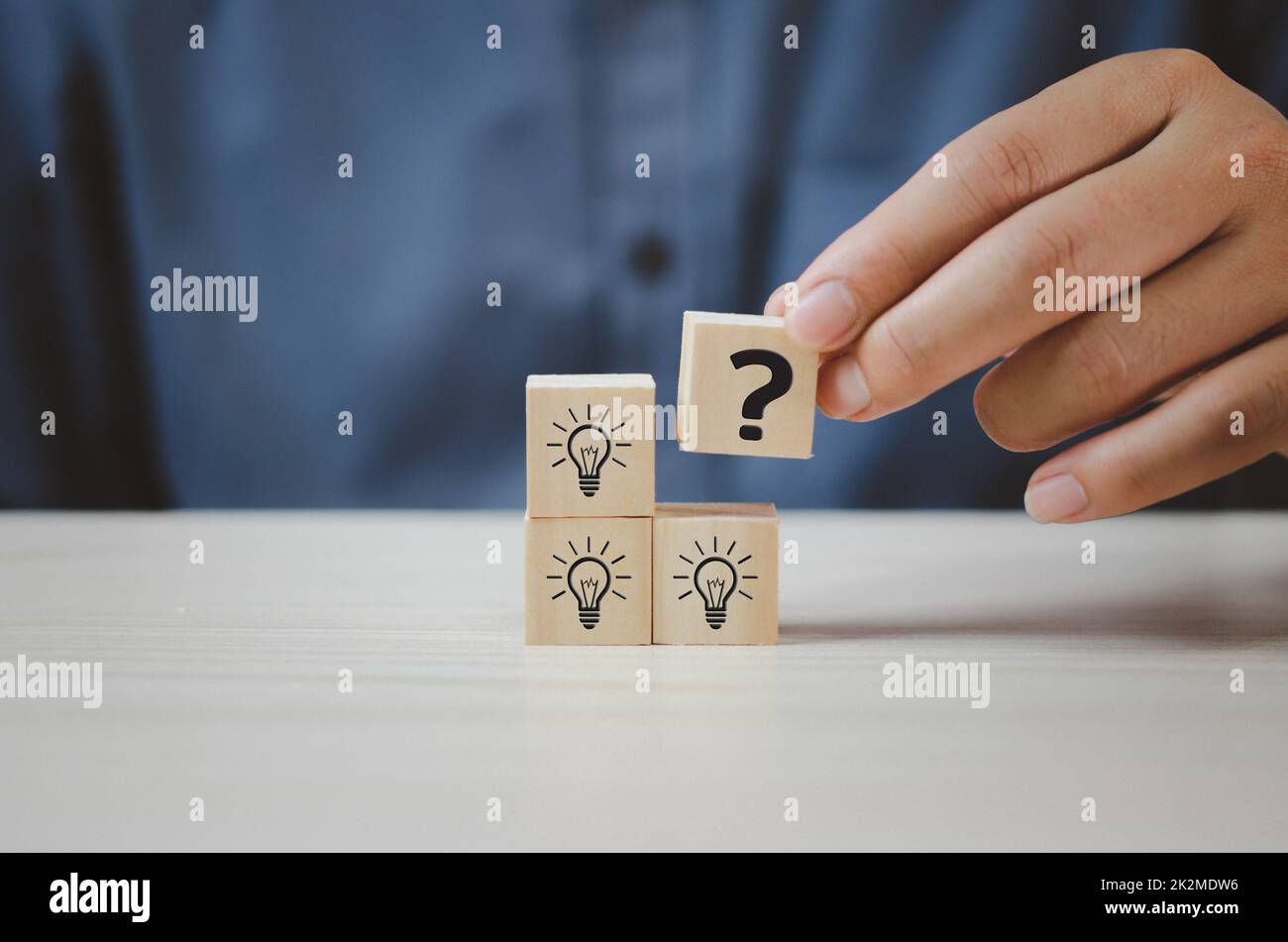 Hand put wooden cubes with question mark symbol on table and copy space ...