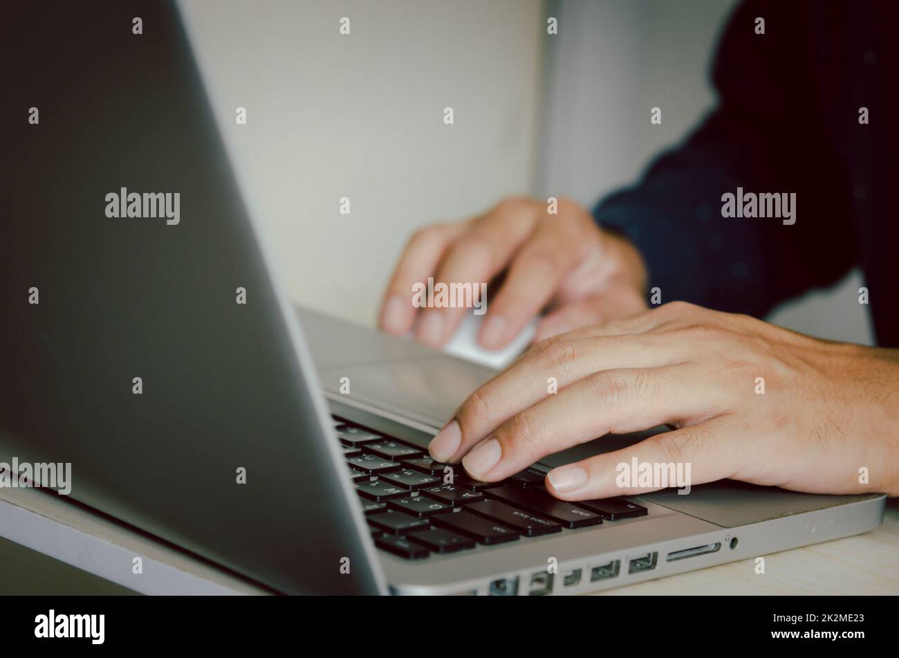 Man hand using a computer to type on a keyboard to find information on ...