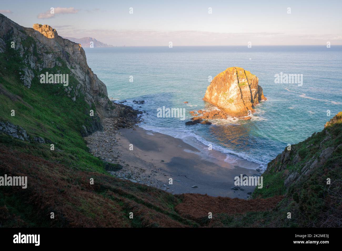 The morning sun illuminates the golden rock known as O Coitelo on the ...