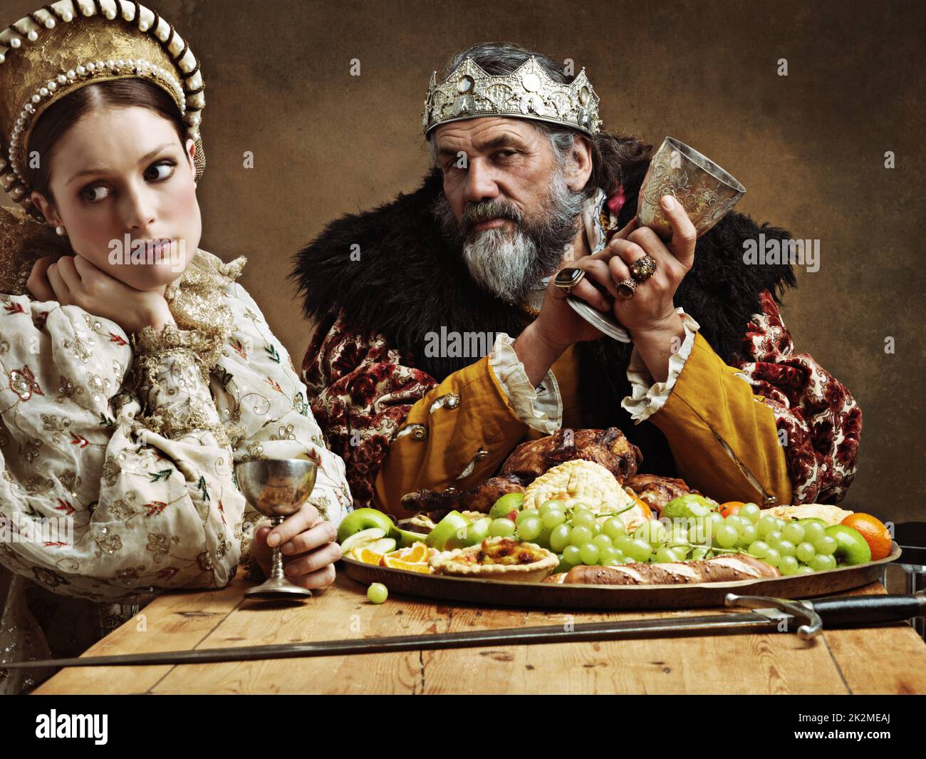 Royal life can be wearisome. A bored queen sitting alongside her ...