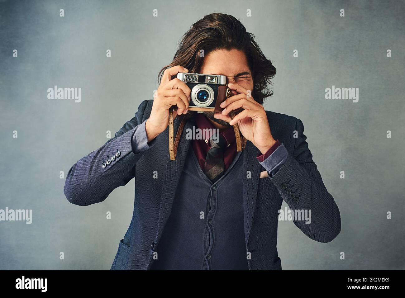 Hes got you framed. Studio shot of a stylishly dressed handsome young ...
