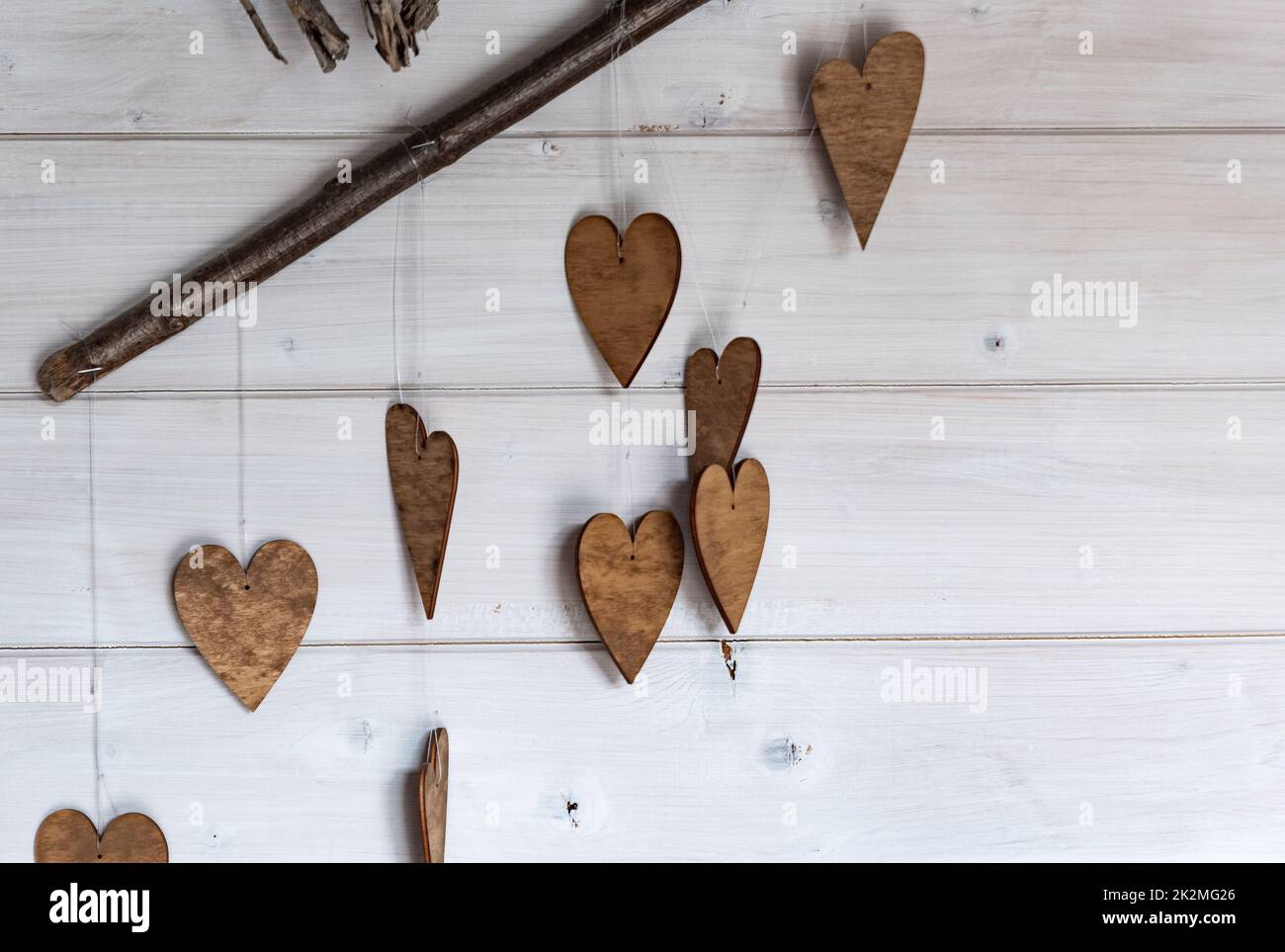 Ornaments in the shape of hearts. Wooden ornaments on the branches ...