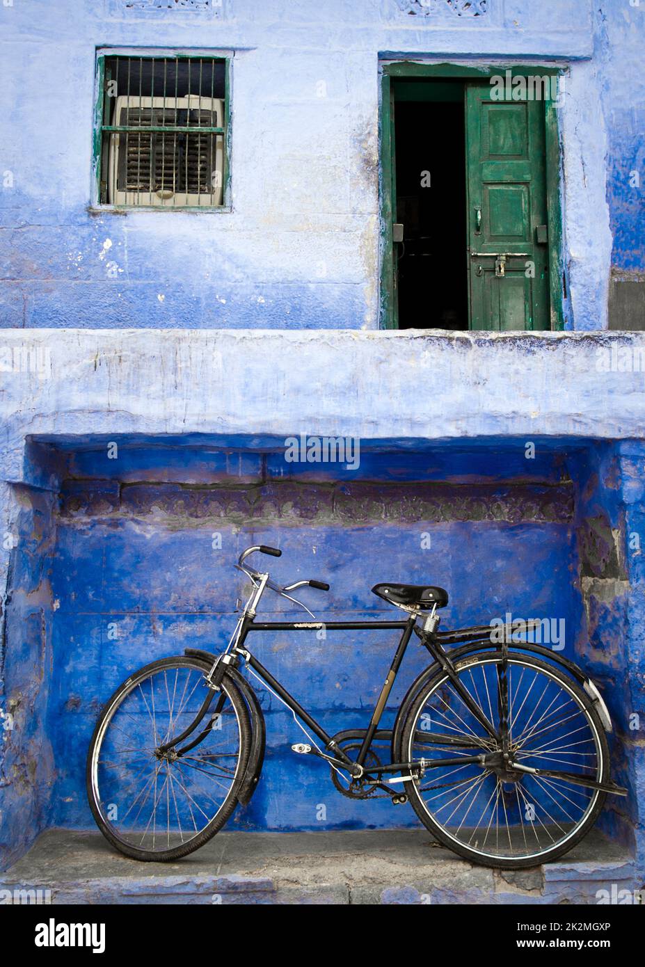 Indian bycicle in front of a painted blue facade house in Jodhpur ...