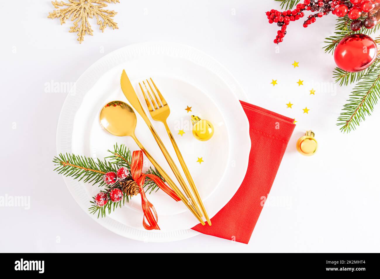 beautiful festive setting of the New Year's table. white plates, a gold ...