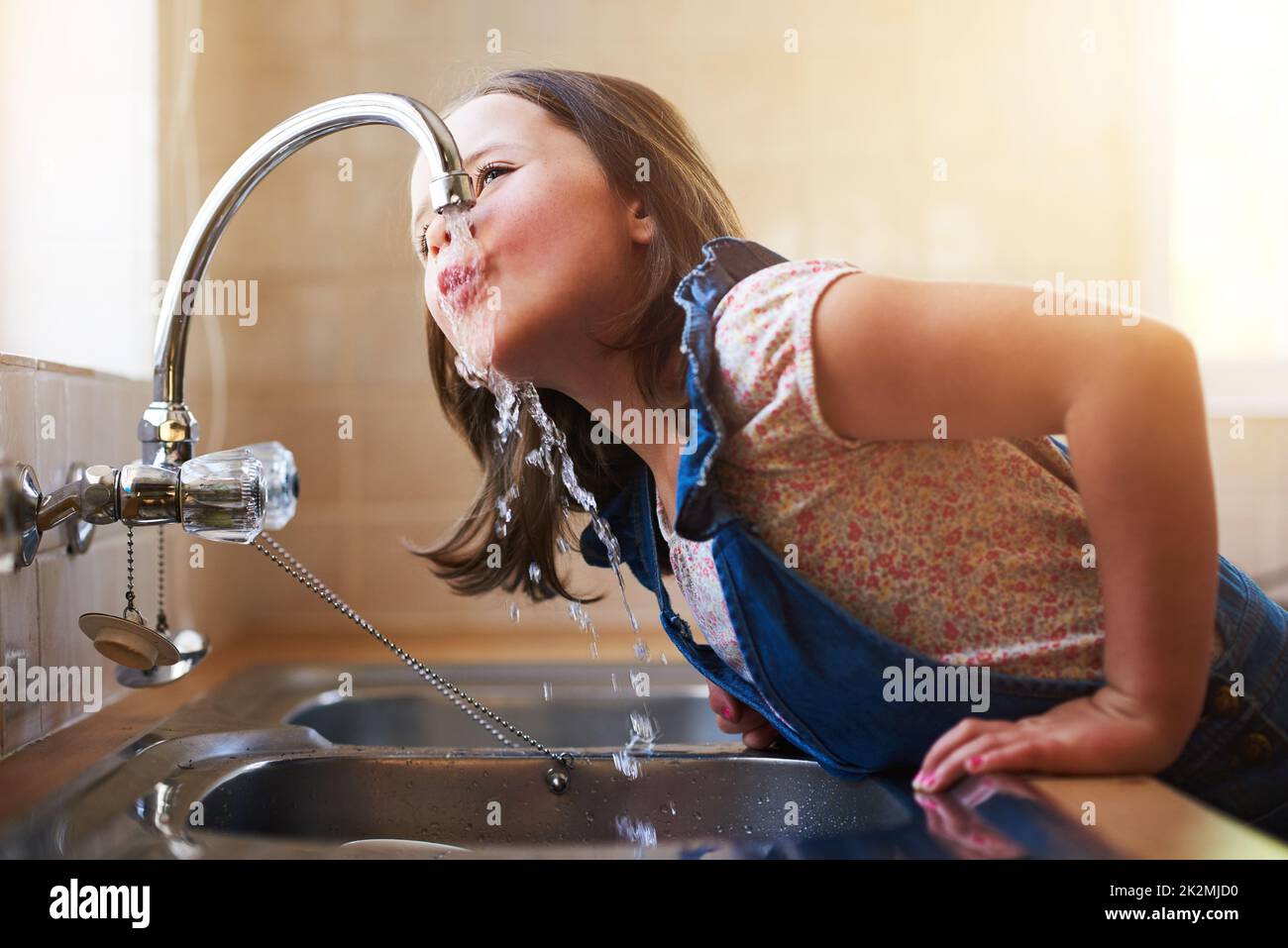 Girl drinking water from tap hi-res stock photography and images - Alamy