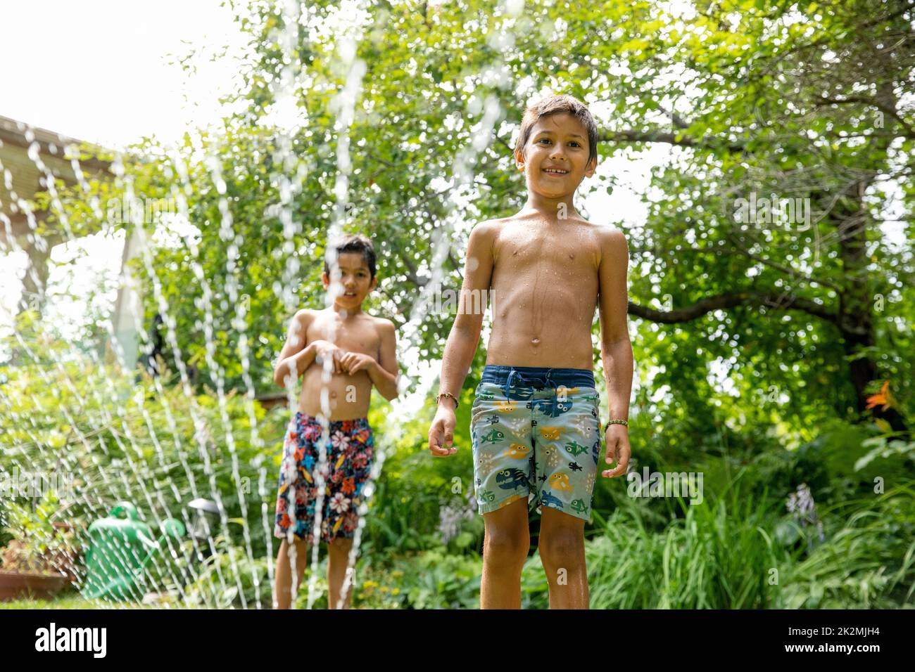 Two boys play in water hi-res stock photography and images - Alamy