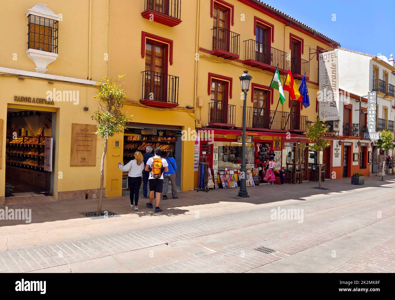 RONDA SPAIN - MAY 2022. Tourist in the shop street of Ronda in a sunny ...