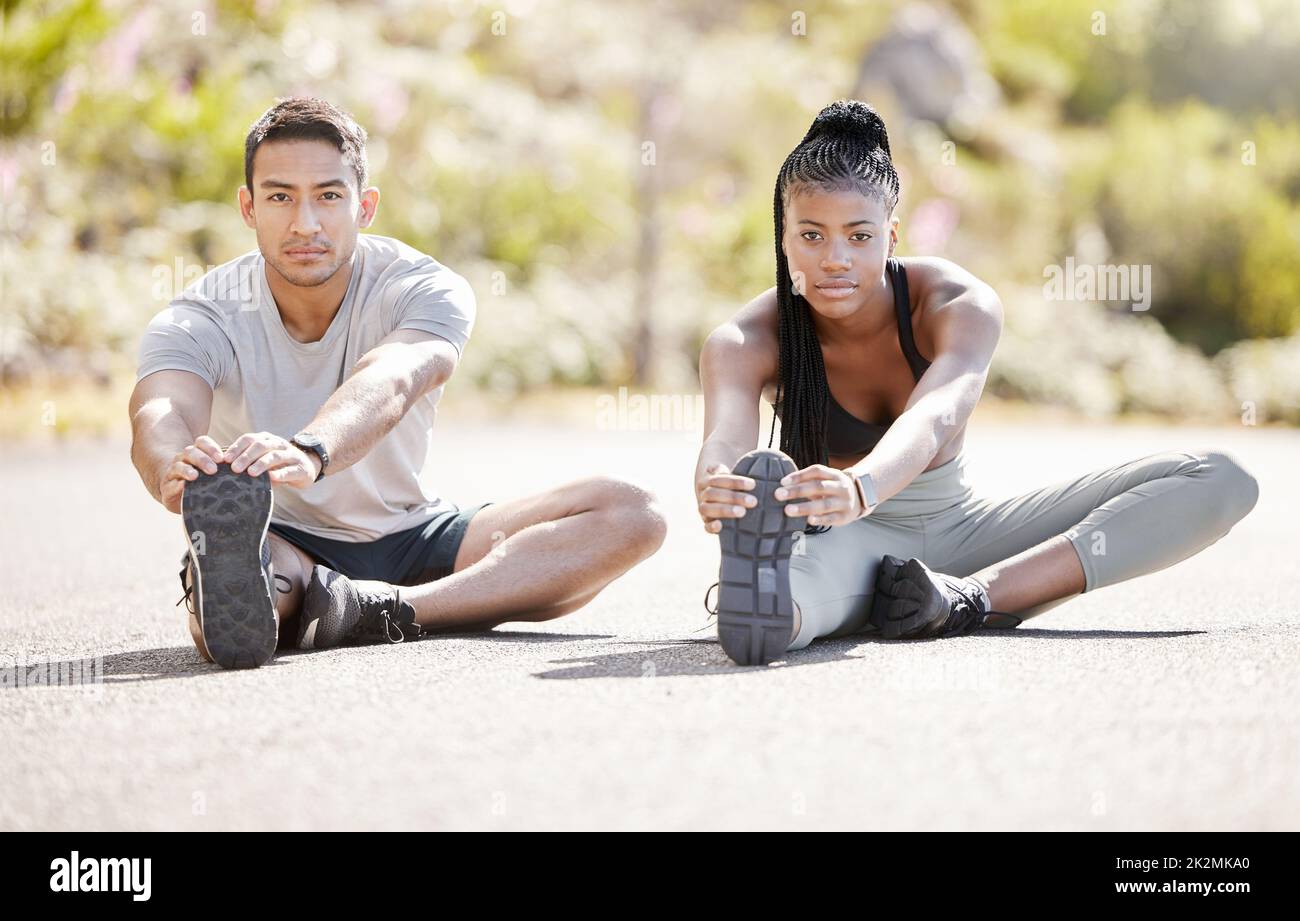 Fitness, road and couple stretching their legs to get ready for running ...