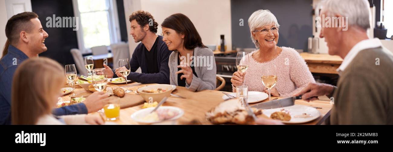 Happy family sitting down dinner hi-res stock photography and images ...