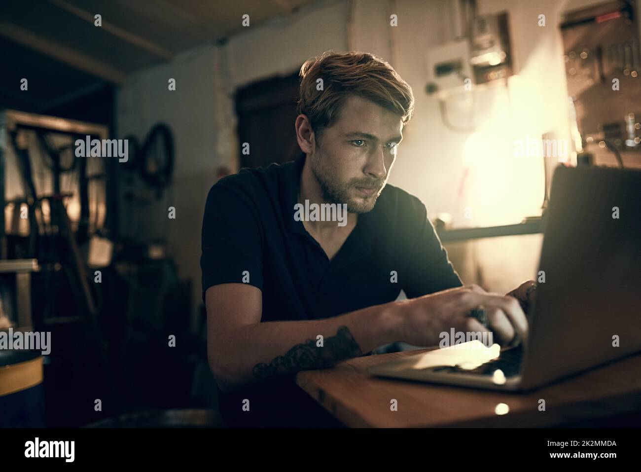 Focused on finishing. Cropped shot of a handsome young man working late ...