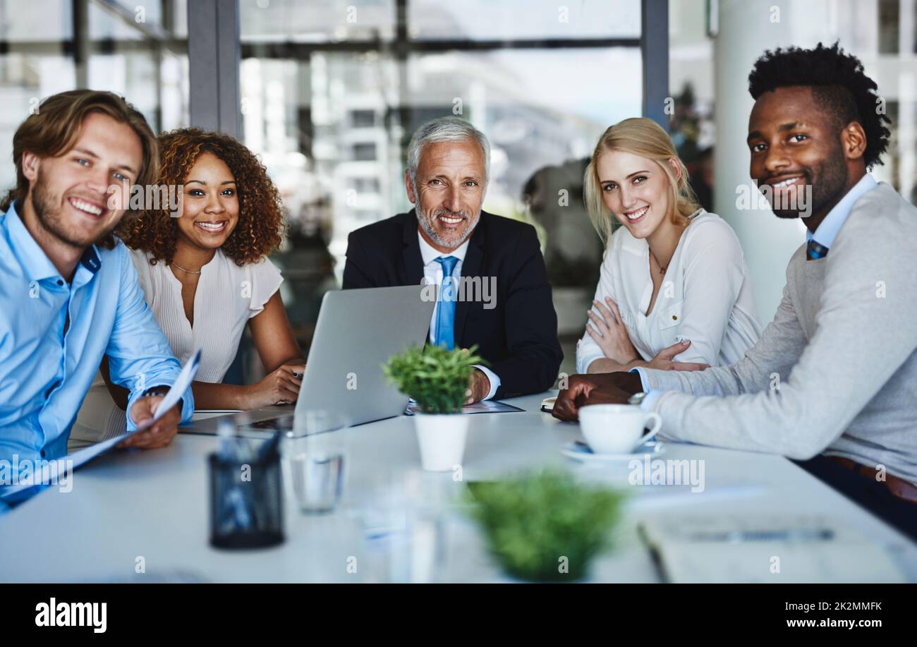 Teamwork makes their meetings work. Portrait of a team of professionals ...