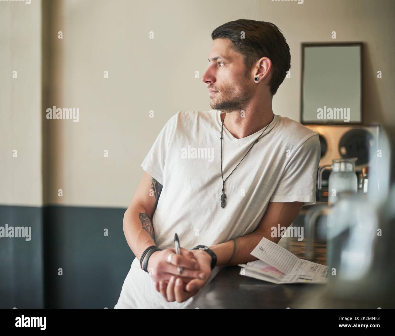 Handsome man leaning on counter hi-res stock photography and images - Alamy