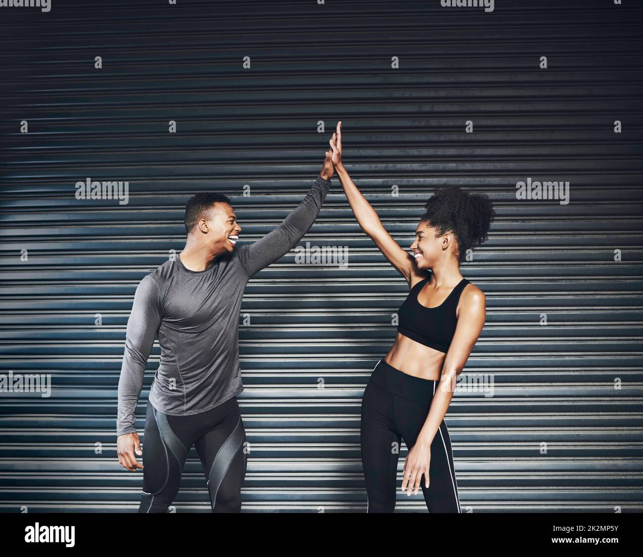 Train hard so you can be proud. Shot of a sporty young couple giving ...