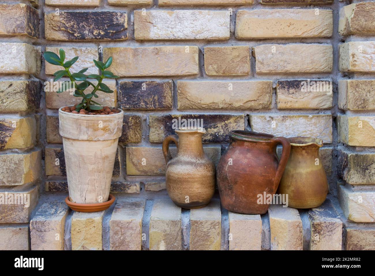 clay pots on a brick wall Stock Photo - Alamy