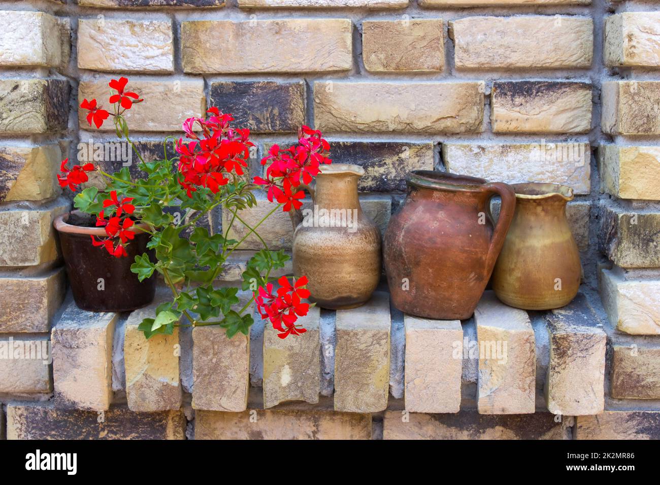 clay pots on a brick wall Stock Photo - Alamy